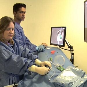 Iris Grunwald (left) demonstrates the use of a surgical simulator ...
